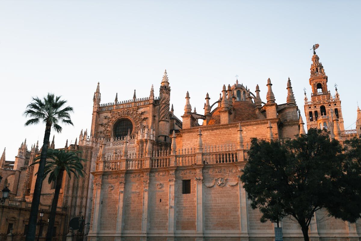 Seville Cathedral illuminated by warm evening light showing its Gothic architecture