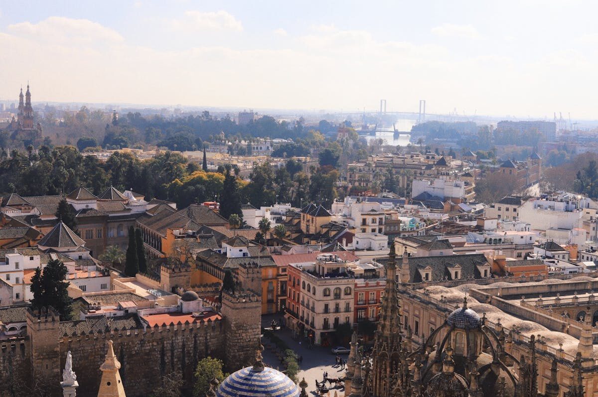 Aerial view of Seville showing historic rooftops with the cathedral dominating the skyline