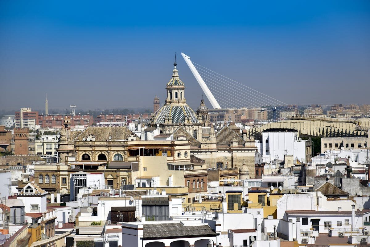 Elevated view of the Seville skyline showing historic buildings and modern bridge
