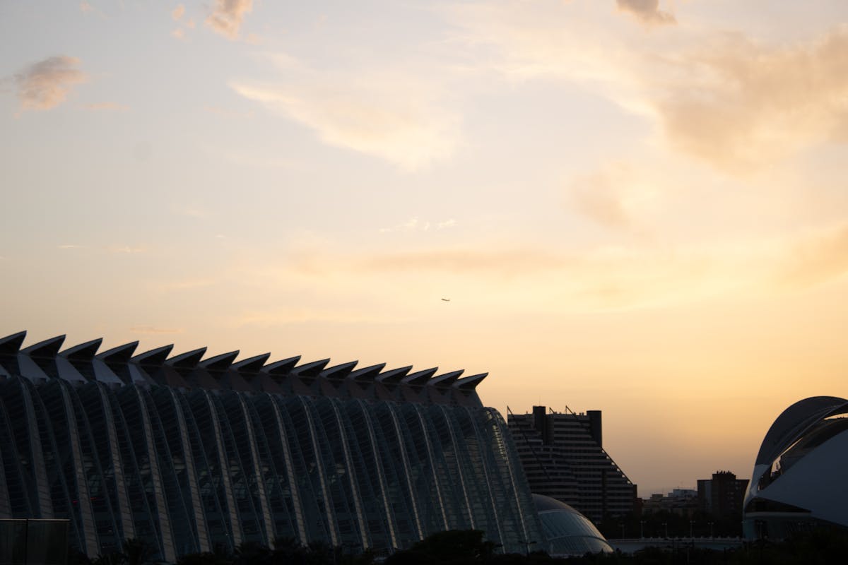 Sunset casting warm golden light over Valencias City of Arts and Sciences with reflections in the water