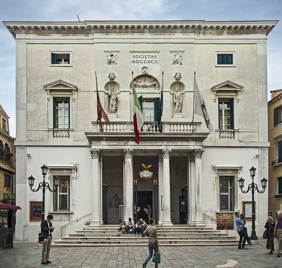 The neoclassical facade of Teatro La Fenice opera house in Venice with its columned entrance
