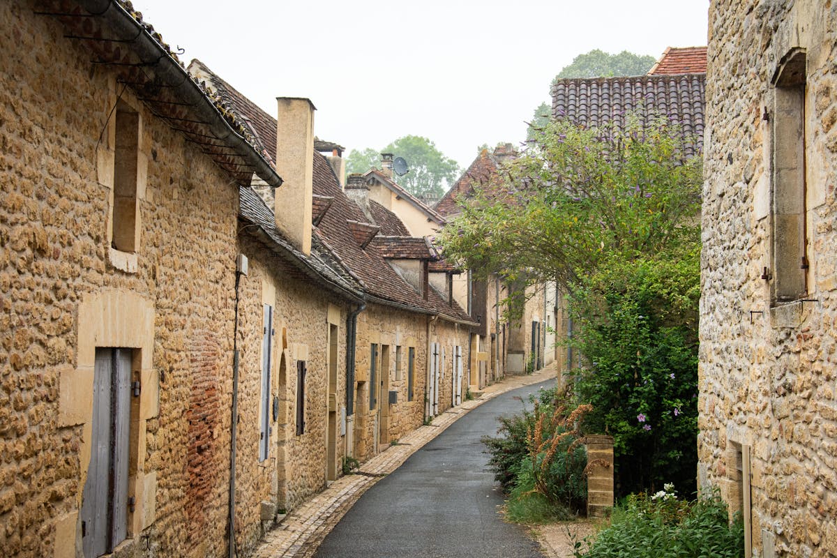 Narrow stone-walled street in a hilltop village in southern France