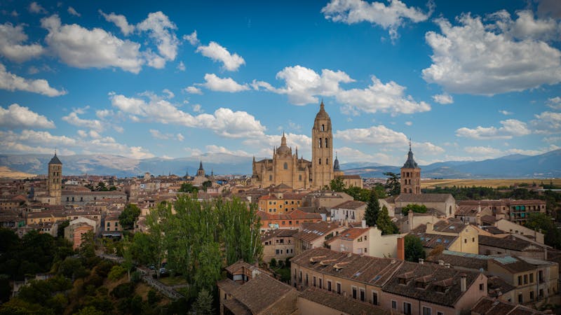 Panoramic view of Segovia showing the cathedral dome and spires rising above the medieval rooftops
