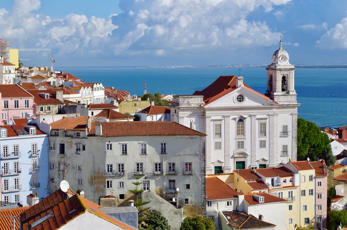 Colorful buildings and church towers in Alfama district overlooking Lisbon