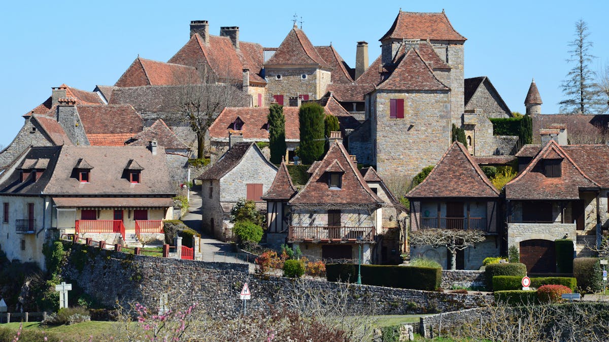 Traditional French village with stone buildings under a clear blue sky