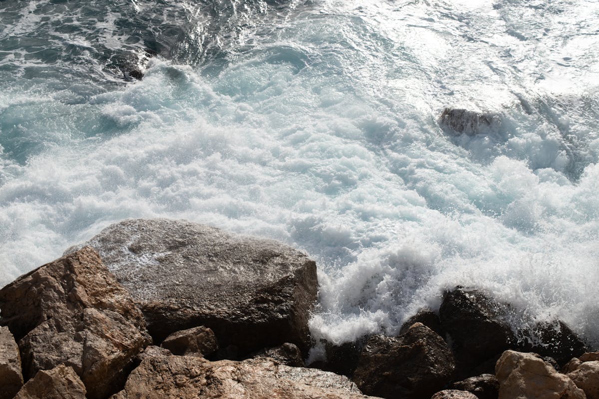 Waves crashing on a rocky shore along the Nice coastline