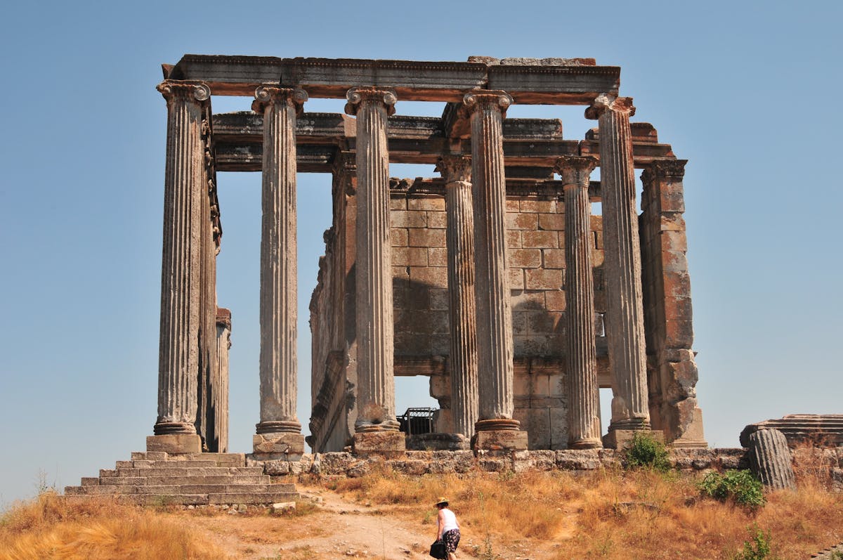 Towering ancient Greek columns under clear blue sky