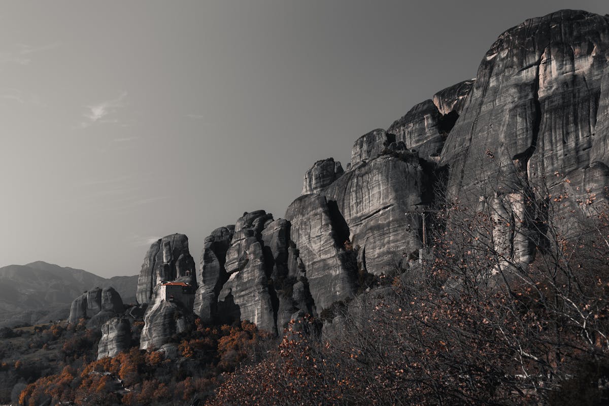 Meteora rock formations in misty landscape
