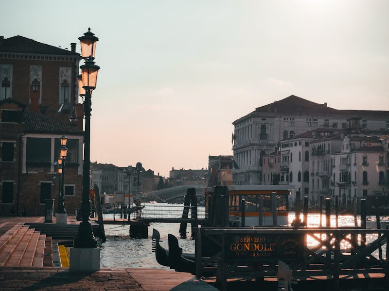 Gondolas moored at the Grand Canal in Venice during a golden sunset