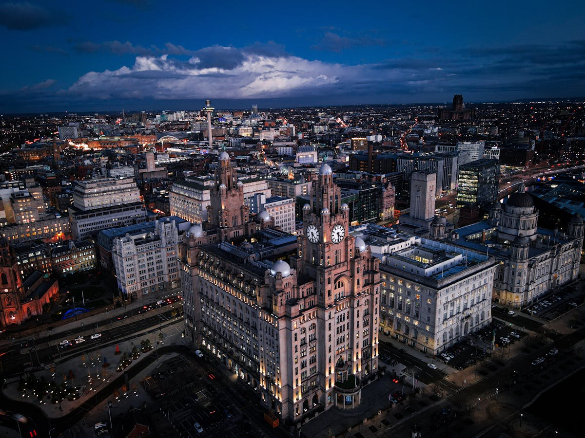 Aerial view of Liverpool cityscape at night with the Liver Building illuminated
