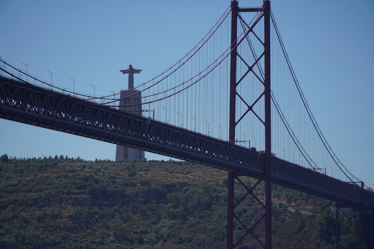 The red 25 de Abril suspension bridge over the Tagus River in Lisbon from a low angle