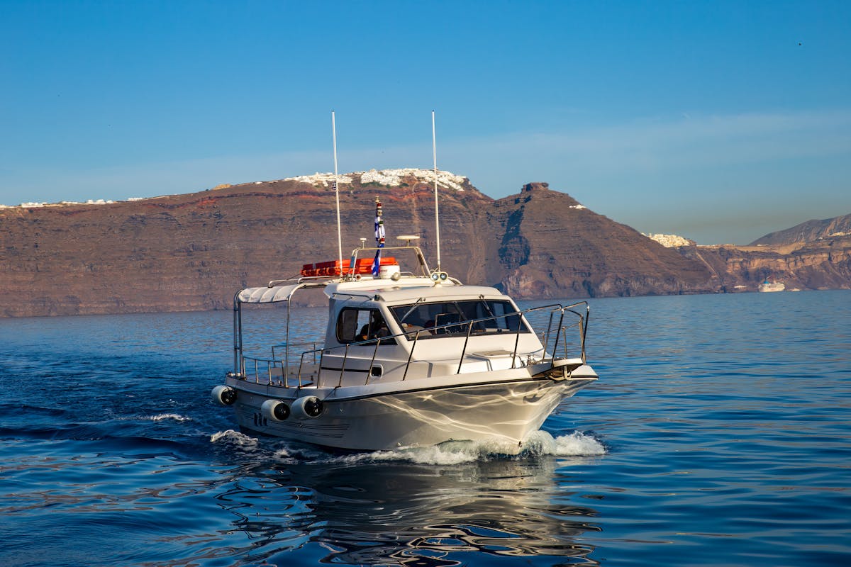 Yacht sailing with Santorini backdrop