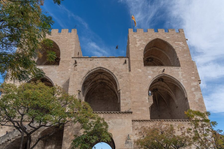 Historic Torres de Serranos gate tower in Valencia against blue sky