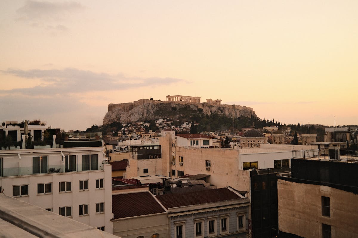 The Acropolis of Athens silhouetted against a warm sunset sky