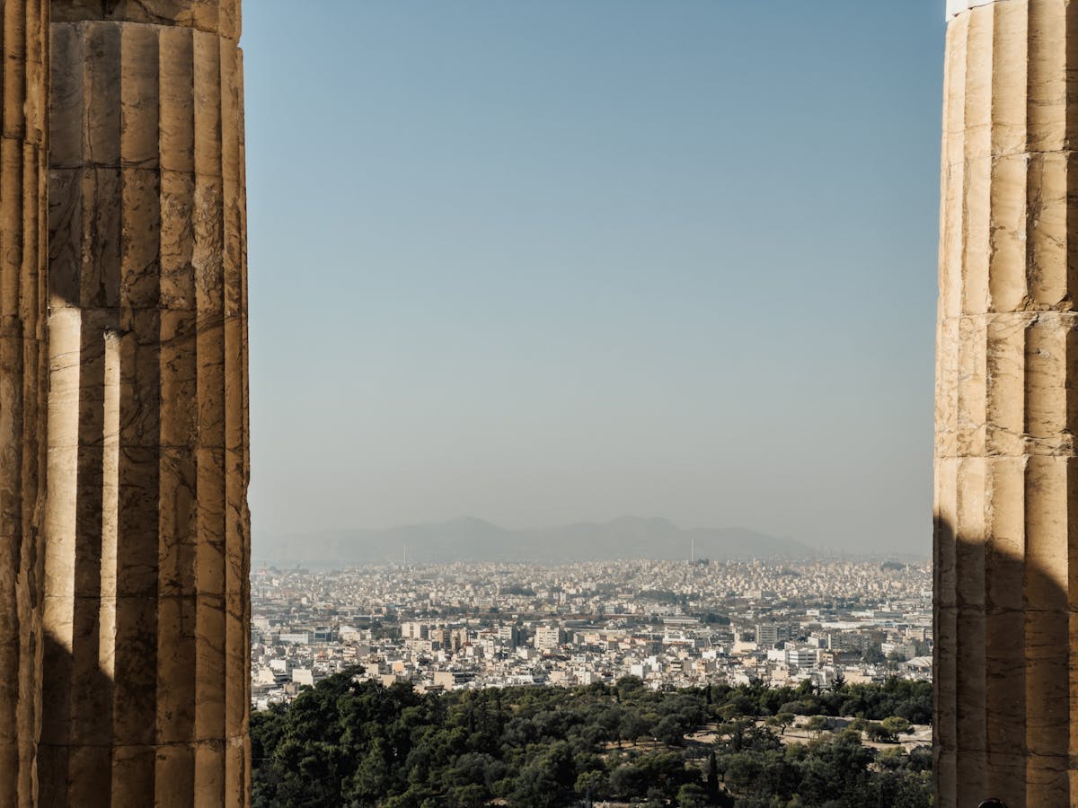 View of Athens through ancient Greek columns at the Acropolis