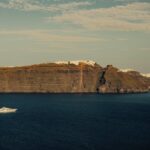 Santorini steep coastline with cruise ship in the Aegean Sea