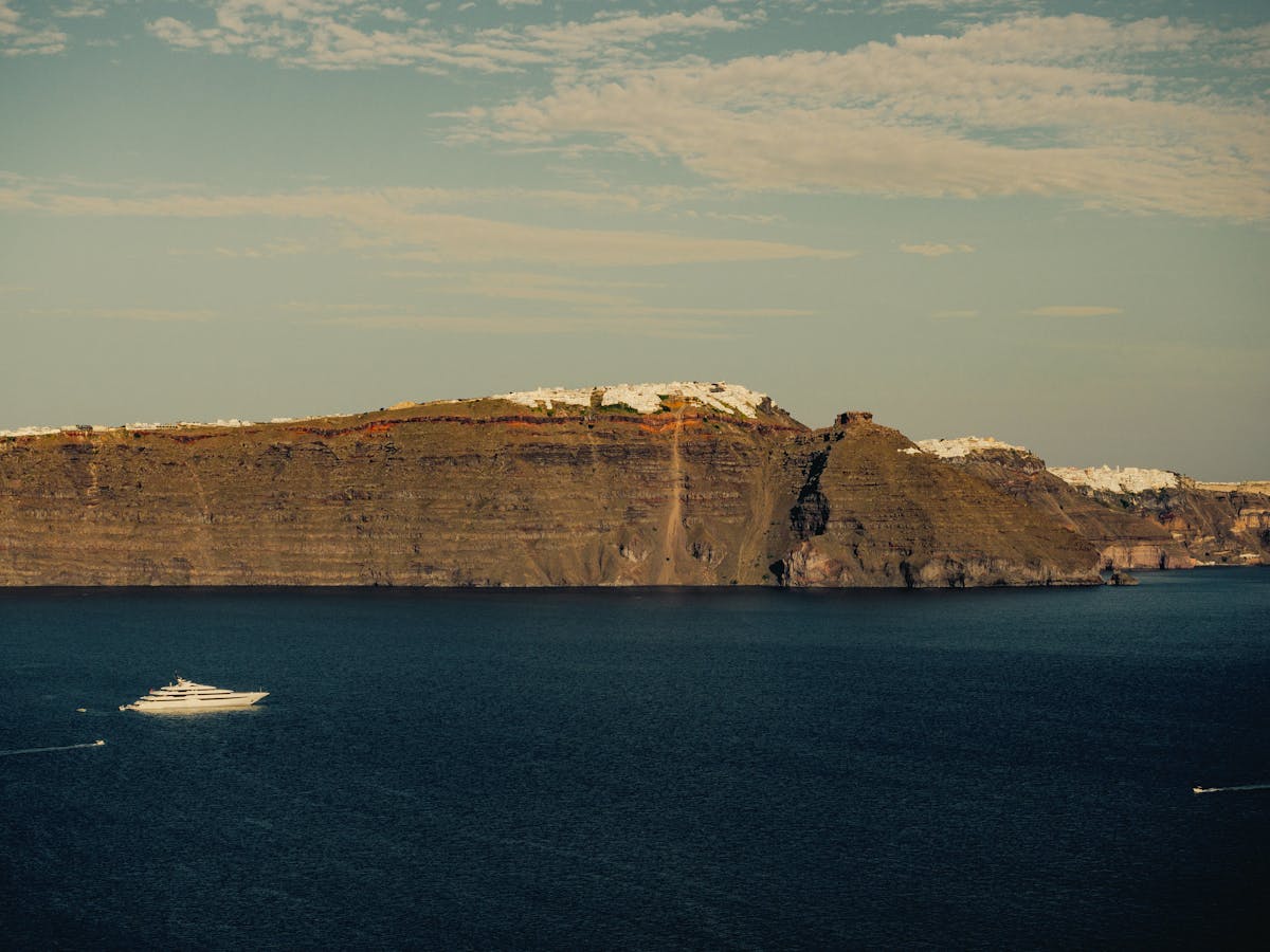 Santorini steep coastline with cruise ship in the Aegean Sea