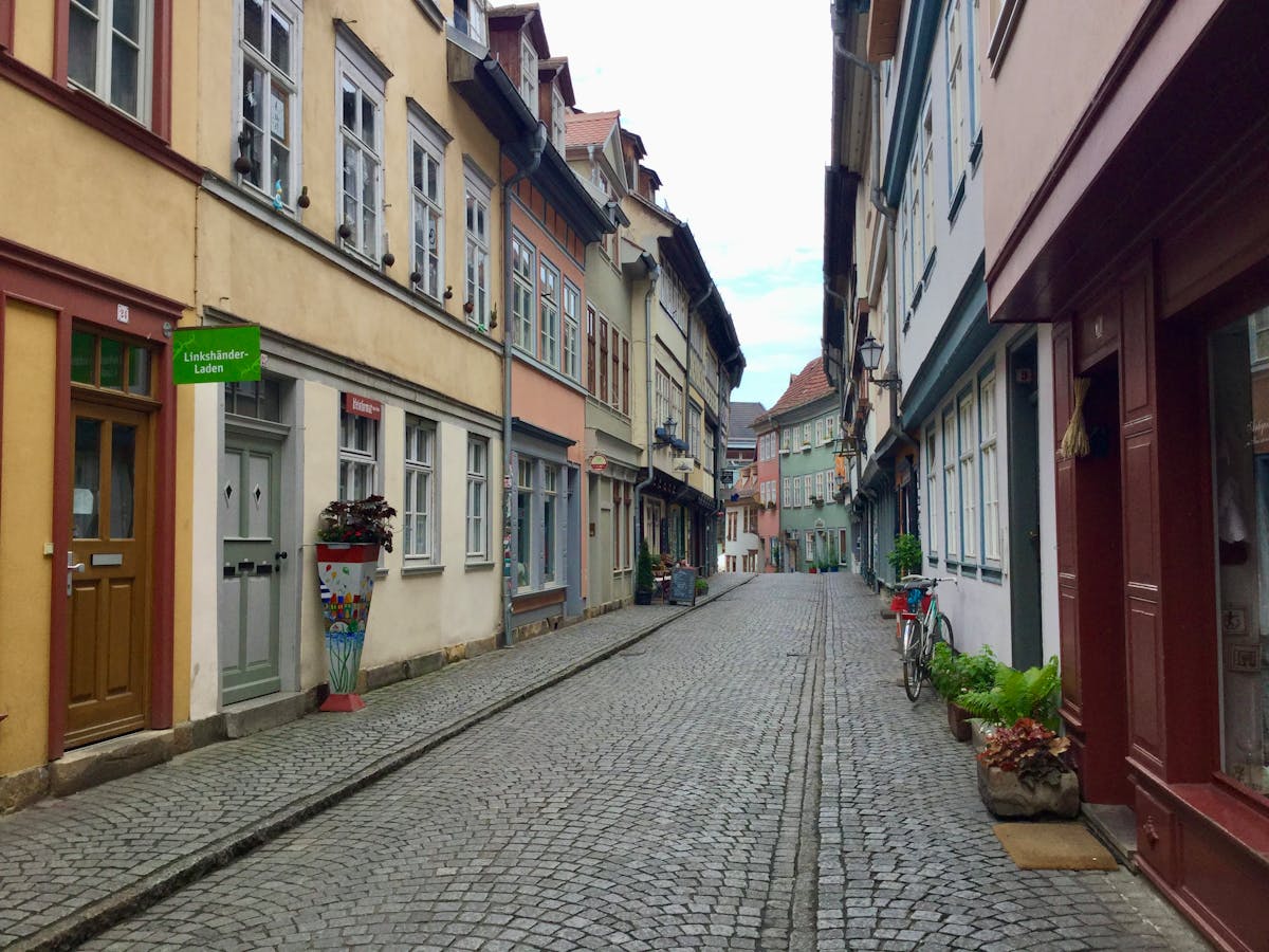 Cobblestone street lined with historic buildings in a European old town