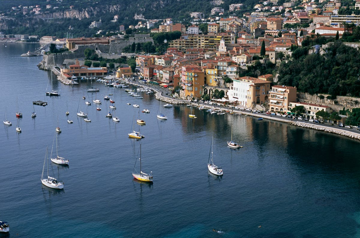 Aerial view of Villefranche-sur-Mer harbor with colorful waterfront buildings and sailboats