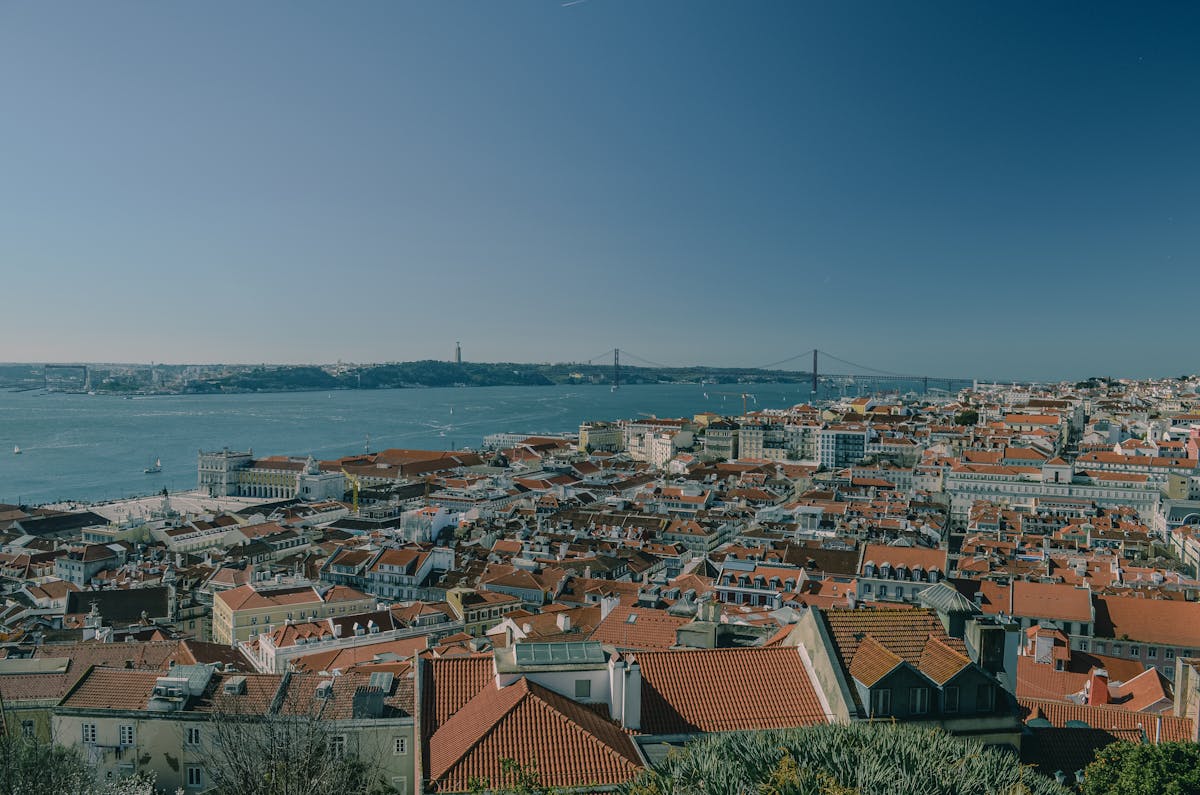 Aerial panoramic view showing Lisbon rooftops with the Tagus River in the background