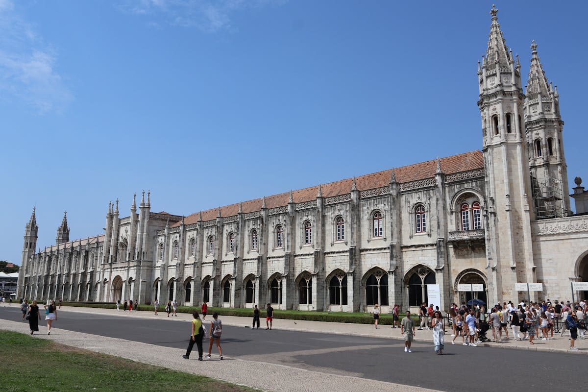 The ornate facade of Jeronimos Monastery in Lisbon Belem district under blue sky