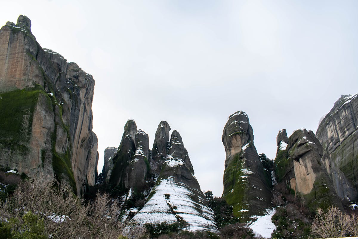 Snow-covered Meteora rock formations in winter