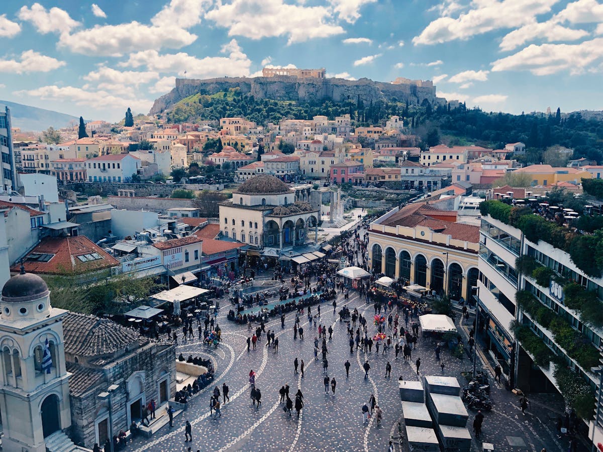 Aerial view of Monastiraki Square in Athens with crowds and the Acropolis