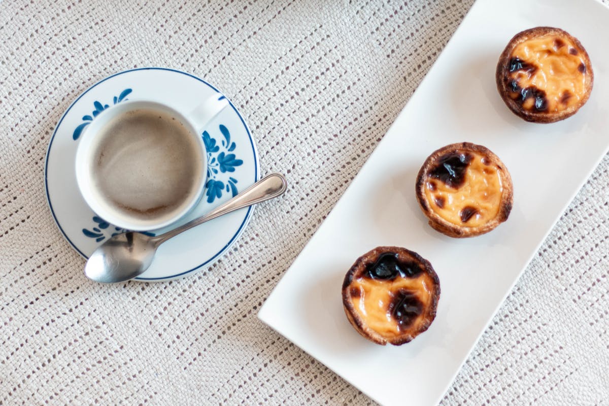 Portuguese egg custard pastries on a white ceramic plate
