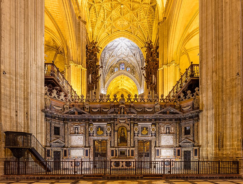 The ornate trascoro wall inside Seville Cathedral with detailed Renaissance stone carvings