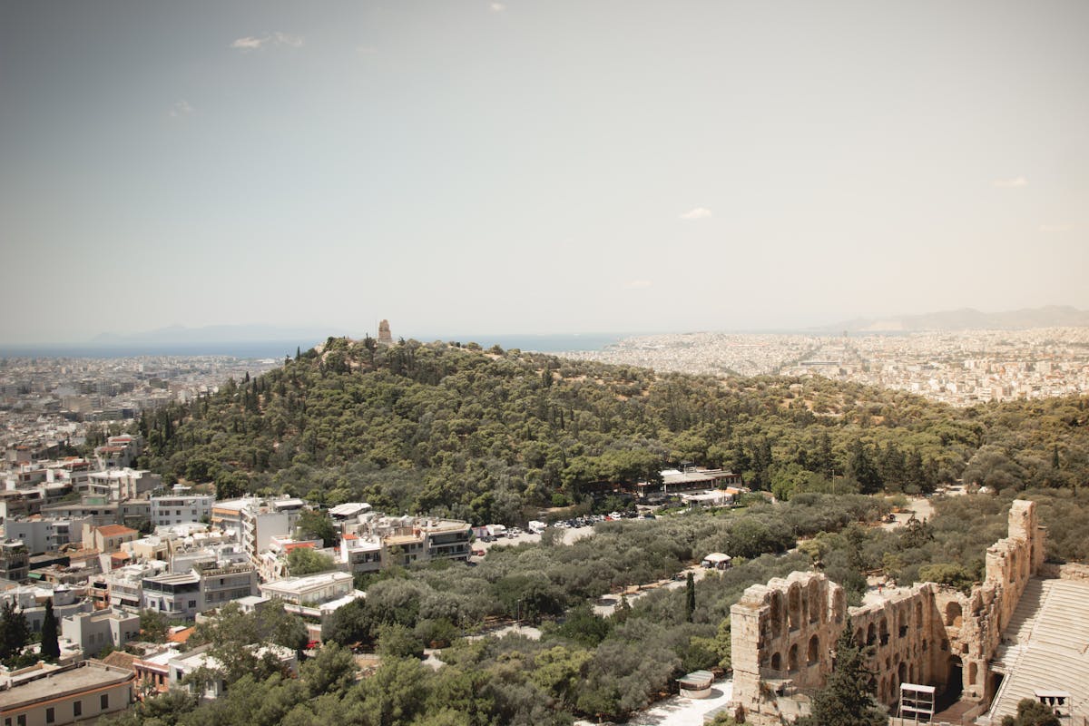 Panoramic view of Athens showing ancient ruins surrounded by trees