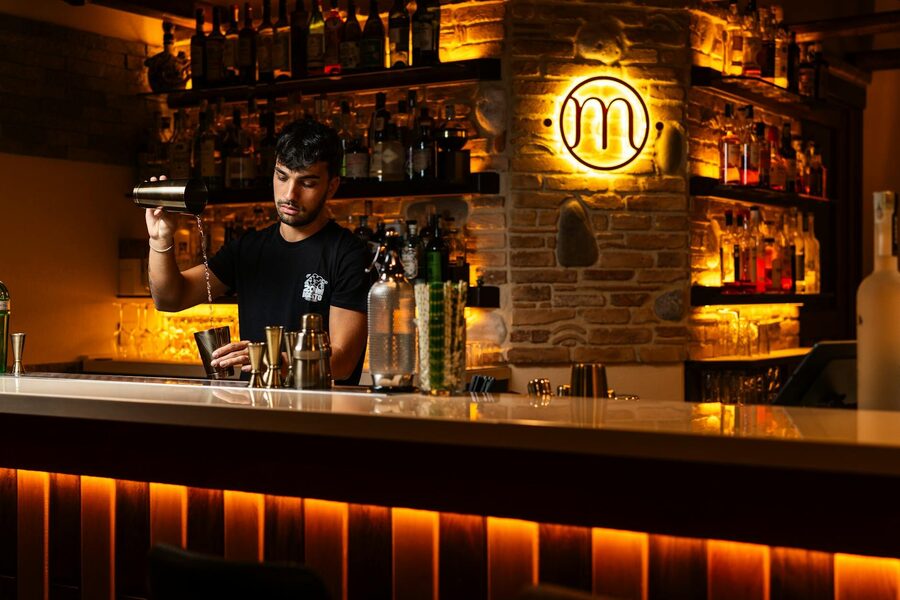 Bartender mixing drinks in a stylish dimly lit bar