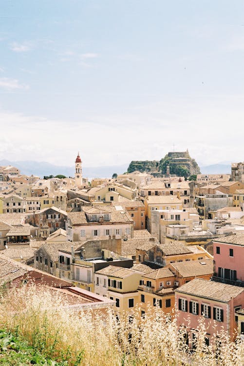 A picturesque aerial view of the charming old town of Corfu, Greece, showcasing its rustic rooftops and historic archite