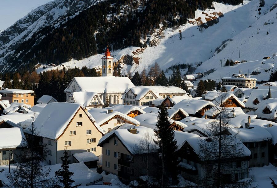 Snowy fjord village of Flam Norway with mountain reflections in winter