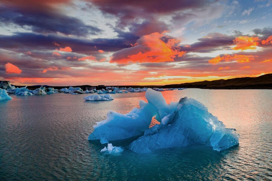 A stunning view of icebergs at sunset in Jokulsarlon Glacier Lagoon, Iceland.