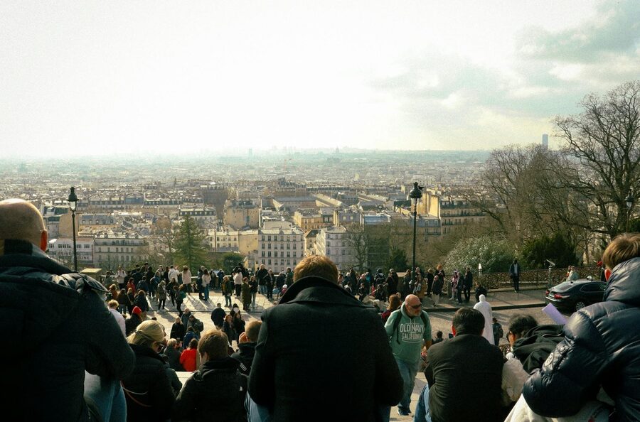 Crowd of travelers gathering at the base of the Eiffel Tower in Paris