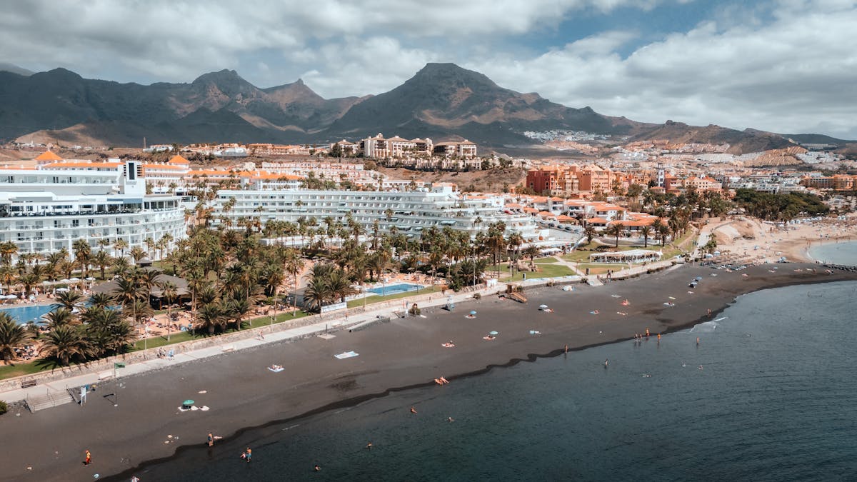 Aerial shot of Adeje beachside resorts with mountains