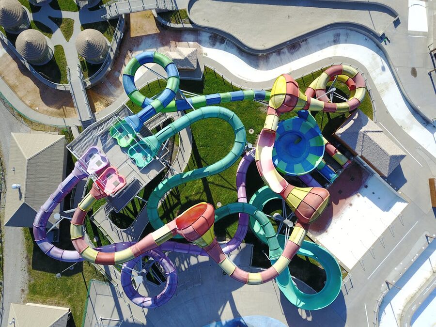 An aerial view showing winding, colorful water slides in an amusement park