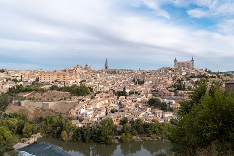 Aerial view of historic Toledo showing churches, towers, and the winding Tagus River