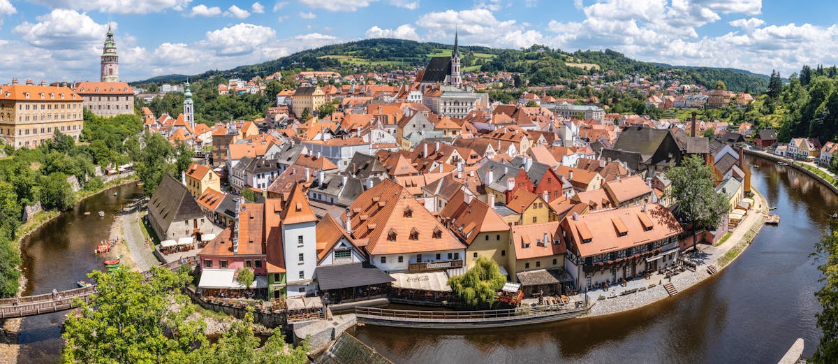 Aerial view of Cesky Krumlov showing the castle red rooftops and the winding Vltava River