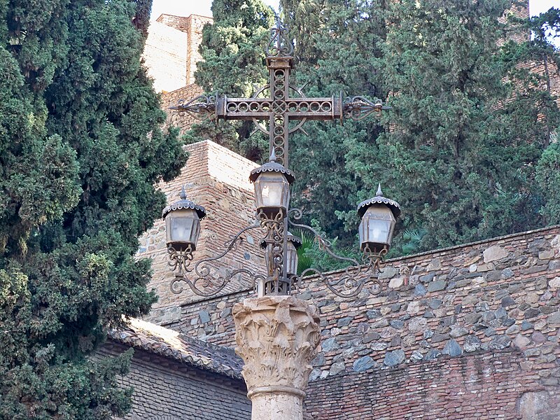 Stone cross monument at the entrance of the Alcazaba in Malaga