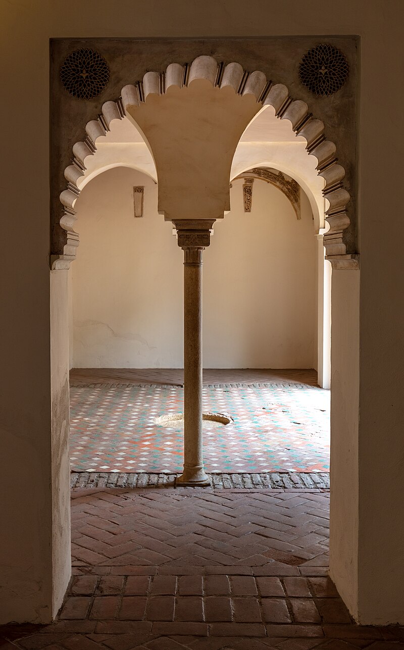 Arched colonnade and garden courtyard inside the Alcazaba palace in Malaga