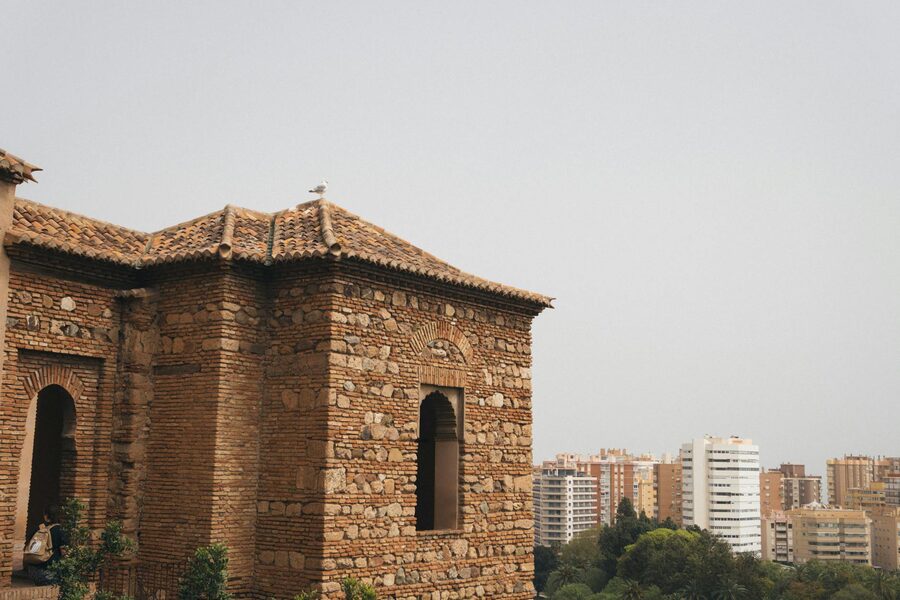 Ancient Alcazaba fortress tower with cityscape backdrop in Malaga