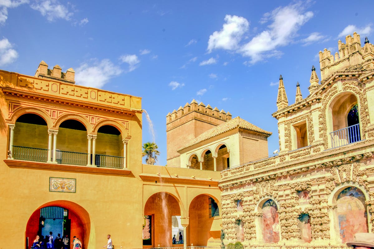 Exterior facade of the Real Alcazar of Seville under blue sky