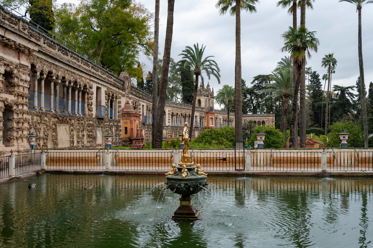 Lush royal gardens of the Alcazar in Seville with historic architecture