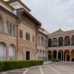Beautiful courtyard view of the Alcazar of Seville showcasing Moorish arches and reflecting pool