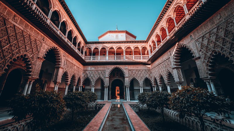 Stunning courtyard with ornate Moorish architecture at the Alcazar of Seville