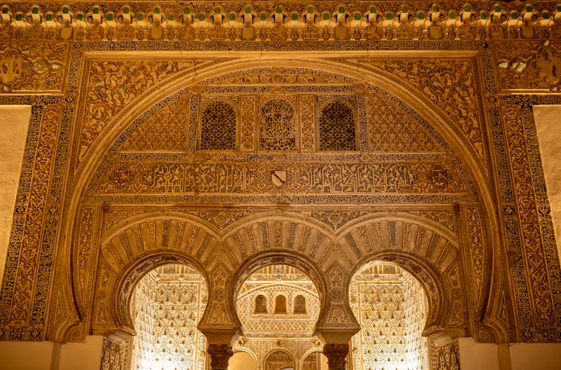 Detailed view of ornate arches showcasing Moorish architecture in the Alcazar of Seville