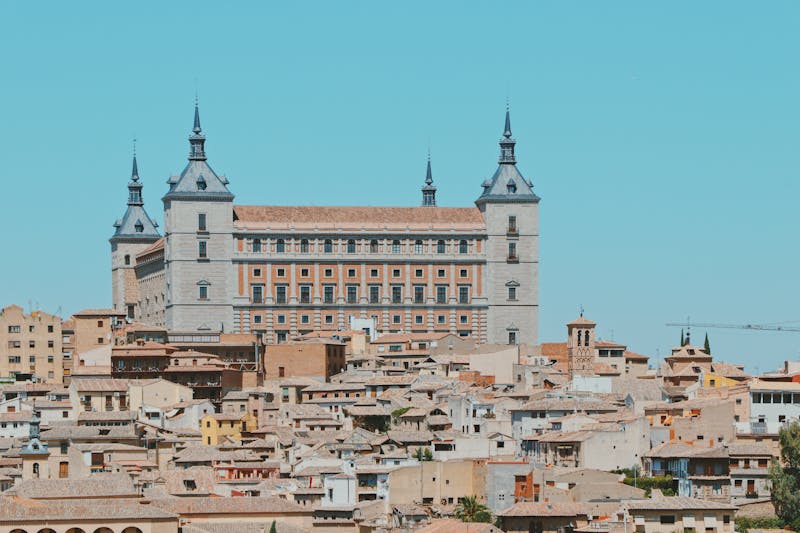 Panoramic view of the Alcazar de Toledo fortress towering over the city rooftops