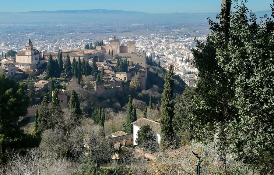 Stunning view of the Alhambra with Granada cityscape surrounded by lush greenery