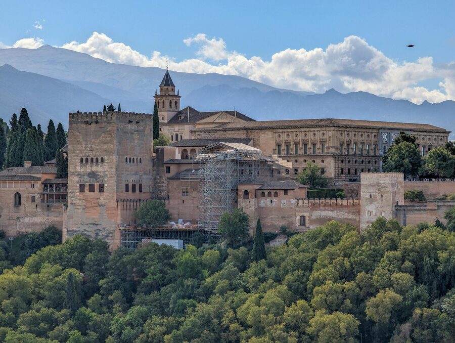 Alhambra Palace set against snow-capped Sierra Nevada mountains in Granada Spain
